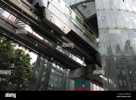 A Monorail Train Of Chongqing Light Rail Line Passes Through A Glass