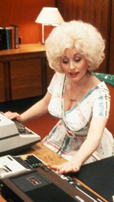 A Woman Sitting At A Desk With An Old Typewriter