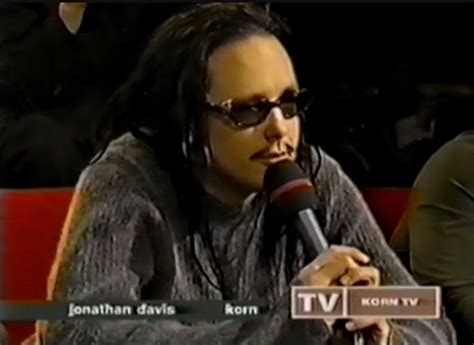 A Woman Sitting In Front Of A Microphone