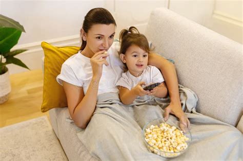 Mom And Daughter Watching Tv With Popcorn On Sofa Stock Image Image Of Comfy Mother 303112273