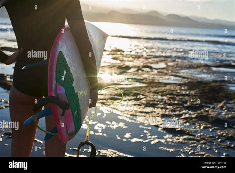 Surfer With Surfboard On Beach Stock Photo Alamy