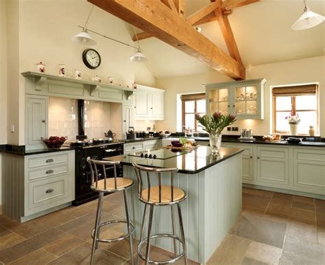 A Large Kitchen With Two Stools In Front Of The Island And Clock On The