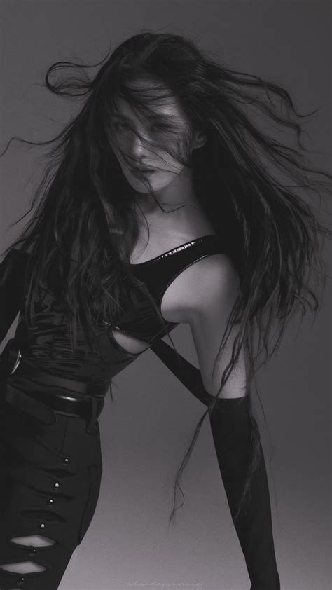 A Woman With Long Hair Is Posing In Black Leather Pants And Boots
