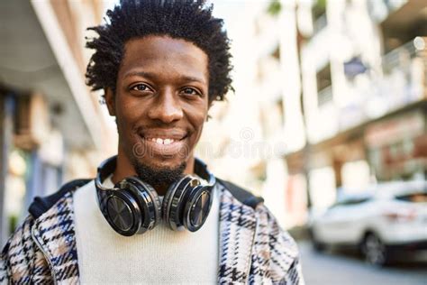 Handsome Black Man With Afro Hair Wearing Headphones Smiling Happy