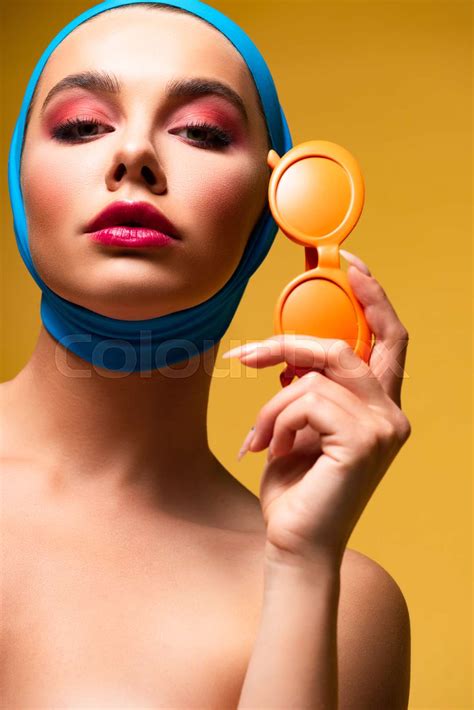 Beautiful Nude Woman In Scarf Holding Sunglasses On Yellow Stock
