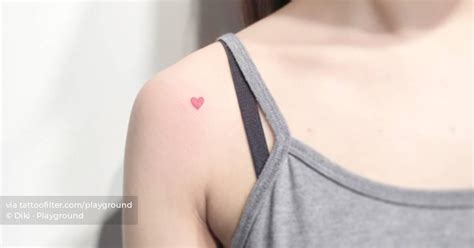 Tattoo Of A Red Heart Located On The Shoulder