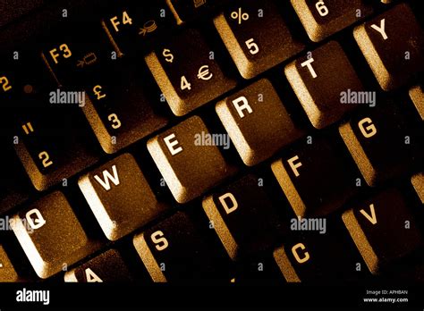 Close Up Of QWERTY Keys On Computer Keyboard With Warm Side Lighting