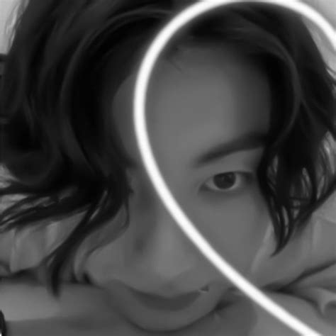 A Woman Laying On Top Of A Bed Next To A White Object In The Air