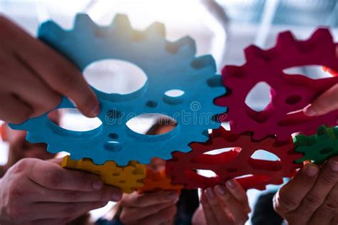 Teamwork Of Business People Work Together And Combine Pieces Of Gears