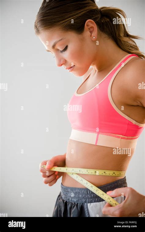 Mixed Race Woman Measuring Her Waist Stock Photo Alamy