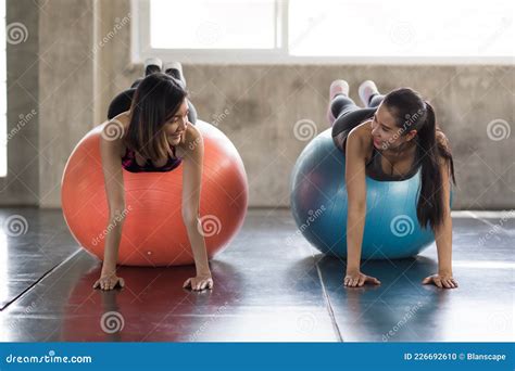 Fit Lesbian Couple Plank On Fitness Ball In Gym Stock Photo Image Of