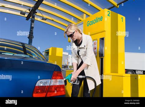 Woman Pumping Gas At A Gas Station Stock Photo Alamy