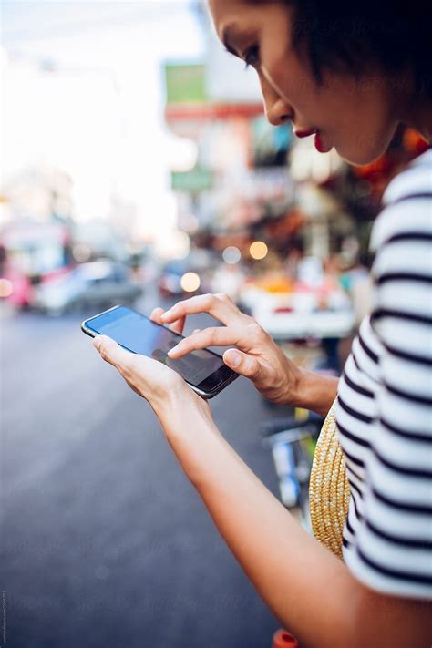 Hand Of Woman Using A Mobile Phone By Stocksy Contributor Lumina
