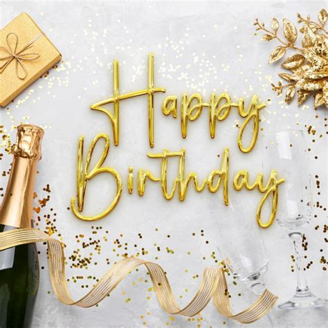 A Bottle Of Champagne And Some Confetti On A White Surface With The