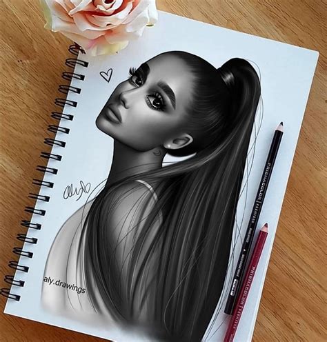 A Drawing Of A Womans Face With Long Hair On Top Of A Notebook