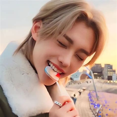 A Woman Brushing Her Teeth With An Electric Toothbrush In Front Of A