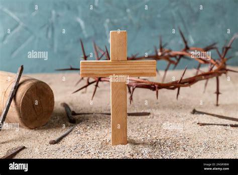 Wooden Cross Crown Of Thorns Nails And Mallet On Sand Closeup Good