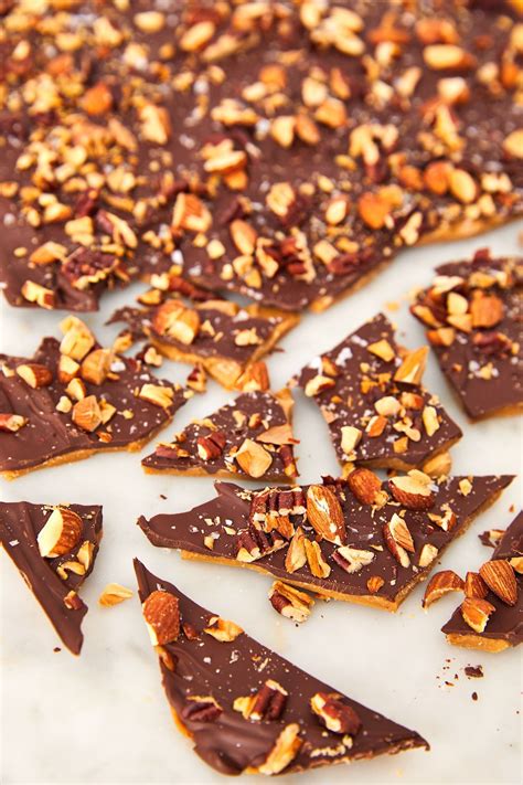 There Are Many Pieces Of Chocolate And Nuts On The Table