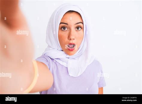 Beautiful Arabian Girl Wearing Hijab Make Selfie By Camera Over Isolated White Background Scared