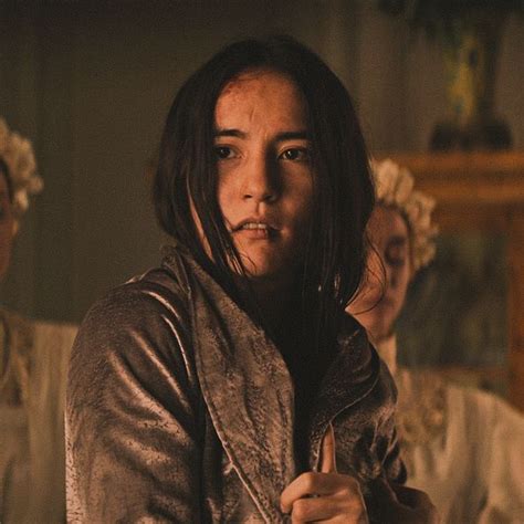 A Woman In A Silver Jacket Holding A Knife