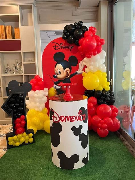 A Mickey Mouse Balloon Display With Balloons In The Background