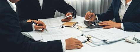 El Equipo De Contables Corporativos Utiliza Una Calculadora Para