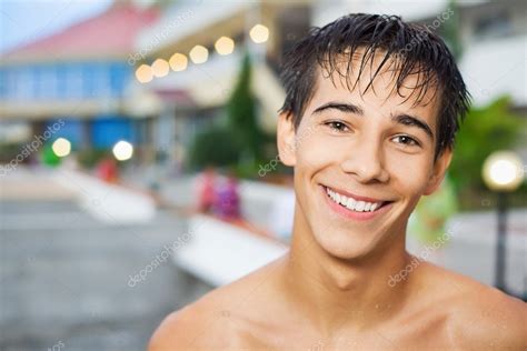 Adolescent souriant debout près de l hôtel en station le soir image
