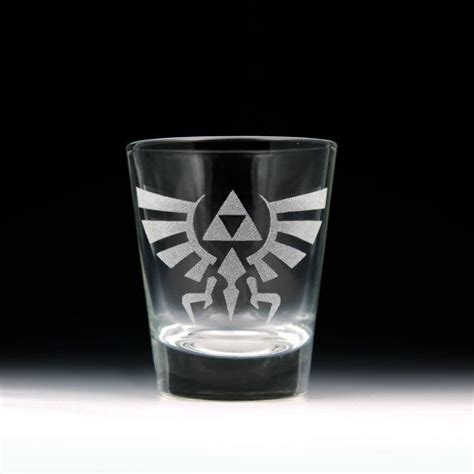 A Glass With The Avengers Symbol On It
