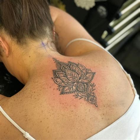 Ornamental Lotus Flower Tattoo On The Upper Back