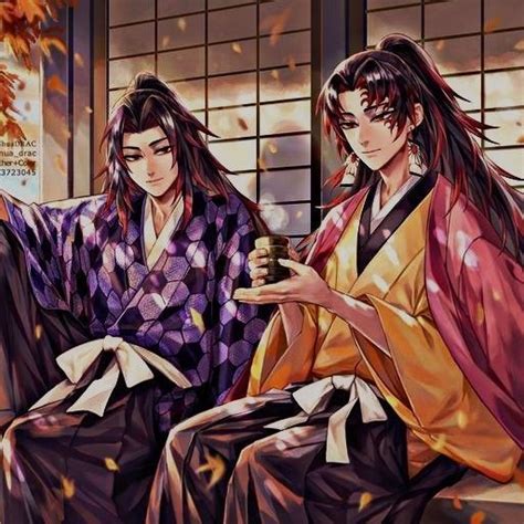 Two Women Dressed In Kimonos Sitting On A Couch With Autumn Leaves