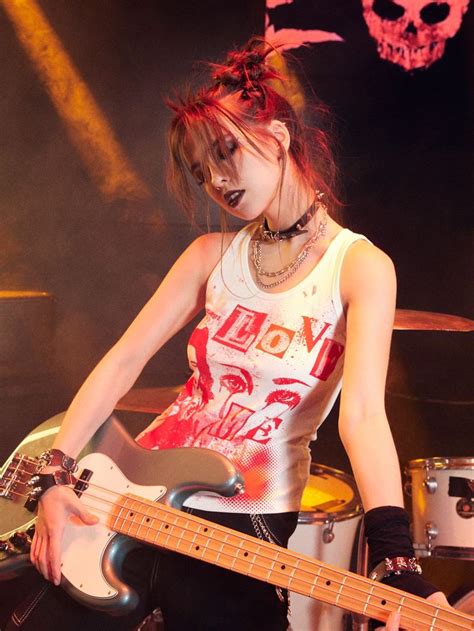 A Woman With Red Hair Playing An Electric Guitar
