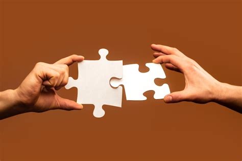 Premium Photo Two Hands Trying To Connect Couple Puzzle Businessman