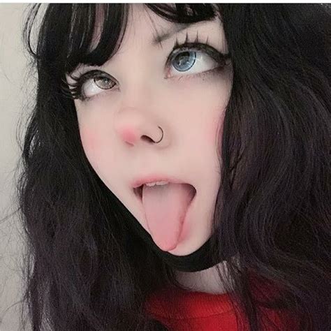 A Close Up Of A Person Making A Funny Face With Her Tongue Out And Eyes Wide Open