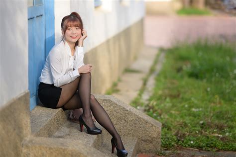 K K Bokeh Brown Haired Side Smile Sitting Hands Skirt Legs