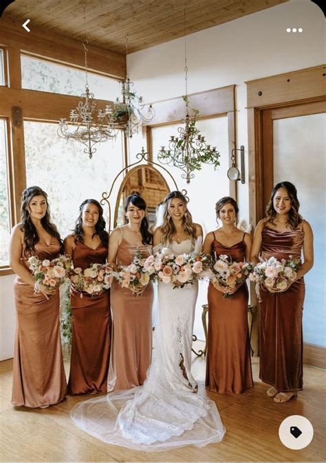 A Group Of Women Standing Next To Each Other Holding Bouquets In Front
