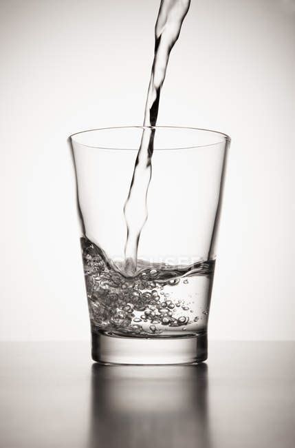 Water Pouring Into Glass On White Background Color Image Nobody
