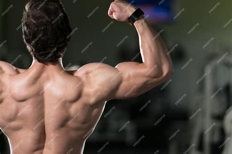 Premium Photo Young Bodybuilder Flexing Rear Double Biceps Pose