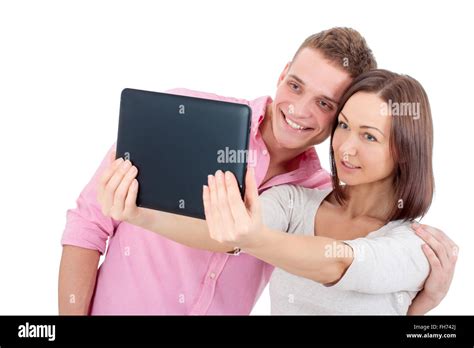 A Young Beautiful Couple Taking A Selfie Selfshot On Their Tablet Pc They Are Embracing Stock
