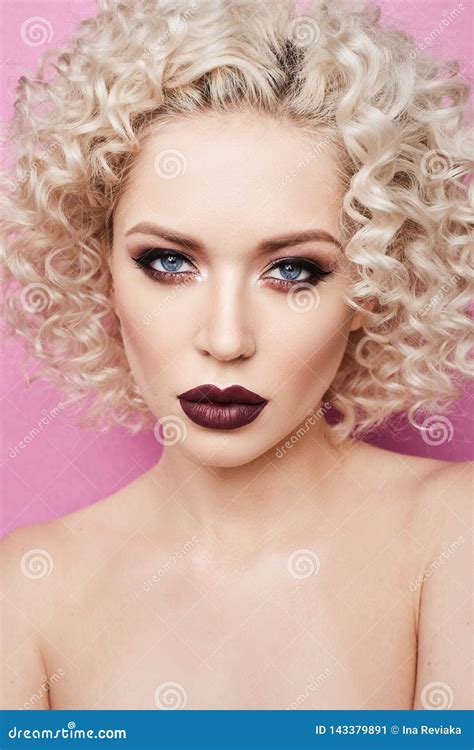 Girl With Curly Blonde Hair And Blue Eyes