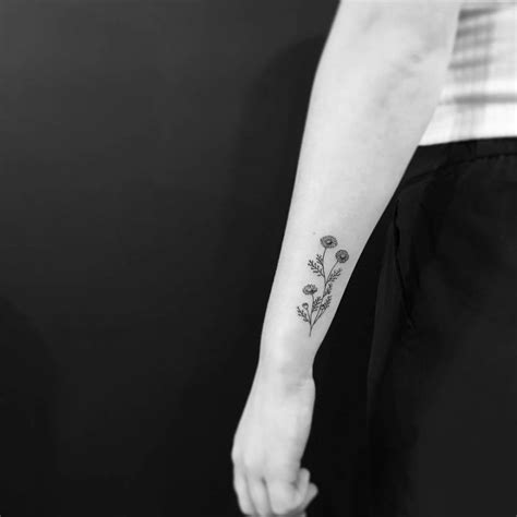 Chamomile Tattoo Located On The Wrist Fine Line Style