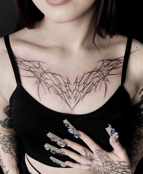 A Woman With Tattoos On Her Chest And Arms