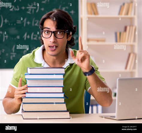 The Handsome Student In Front Of Chalkboard With Formulas Stock Photo