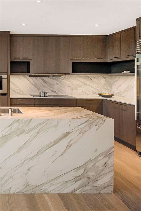 A Large Kitchen With Marble Counter Tops And Wooden Cabinets In The