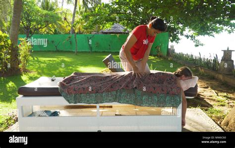 Asian Woman Massage Therapist Doing Massage To Girl Summer Vacation On Luxury Spa Resort