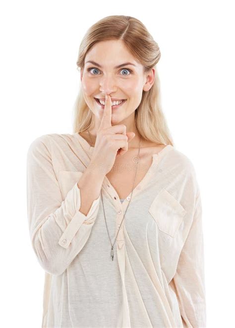 I Have A Secreta Beautiful Young Woman Posing With Her Finger On Her Lips Stock Image