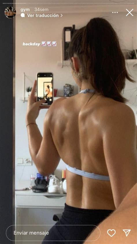 A Woman Taking A Selfie With Her Cell Phone In Front Of Her Back