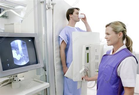 Man Swallowing Barium During An X Ray Stock Image F003 3747