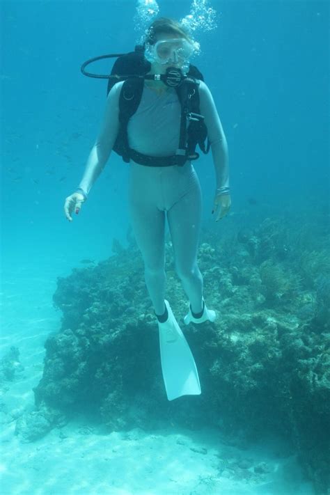 A Woman Scubas In The Ocean With Her Mask On