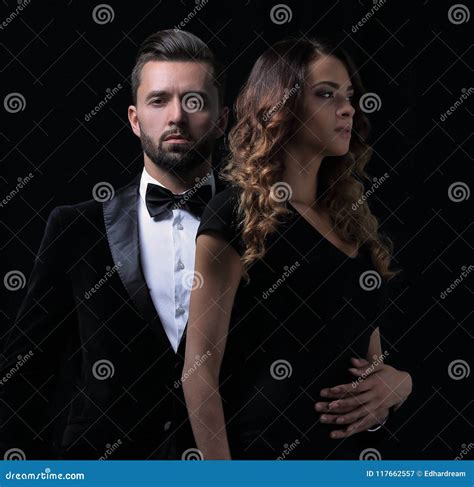 Elegant Man And Woman Posing Next To Each Other On Studio Stock Image