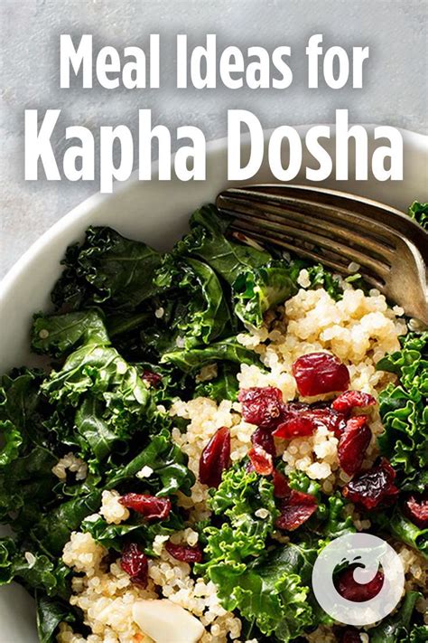 A White Bowl Filled With Kale And Other Food On Top Of A Gray Table